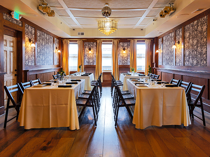 Natural light floods the dining room, where each table's live plant centerpiece silently judges your water consumption habits.