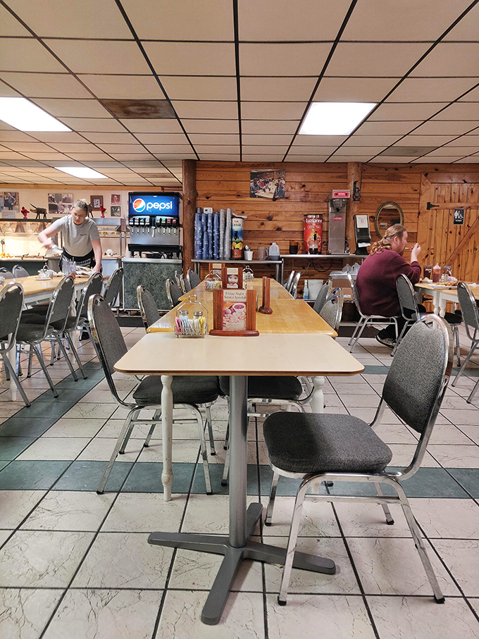 Tables arranged with mathematical precision, each one a blank canvas awaiting masterpieces of overloaded plates and satisfied sighs.