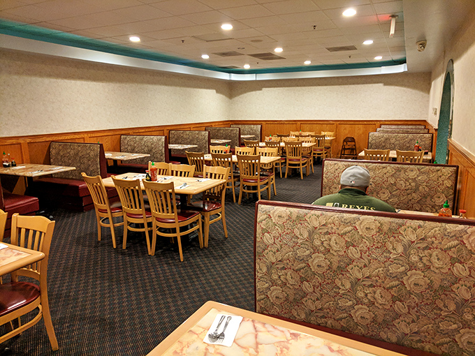 The dining area awaits its hungry patrons like a theater before showtime. Those booths have witnessed countless food comas.