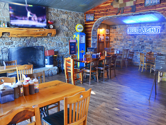 Stone fireplace meets wooden beams in a dining room that feels like the cabin of your dreams—if your dreams included world-class barbecue.
