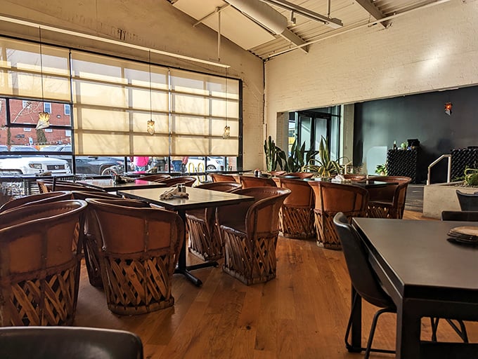 The warm wood tones and equipale chairs aren't just furniture&mdash;they're a visual appetizer before the main event hits your table.