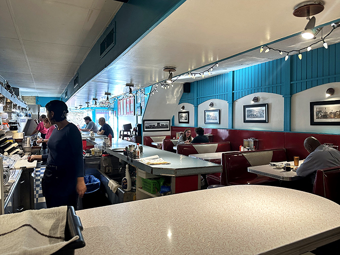 Where strangers become neighbors and neighbors become friends &ndash; the dining room hums with the symphony of forks meeting plates.