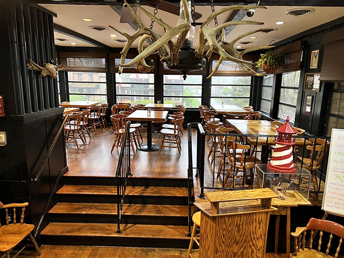 The antler chandelier adds rustic charm to this dining room, where countless crab feasts have unfolded beneath exposed beams and warm lighting.