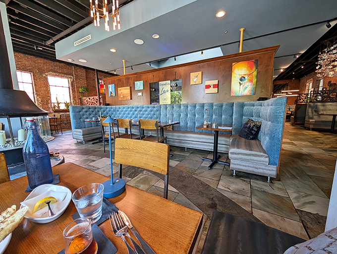 Blue tufted booths and warm wood tones create that rare dining space where you'll want to linger long after the plates are cleared.