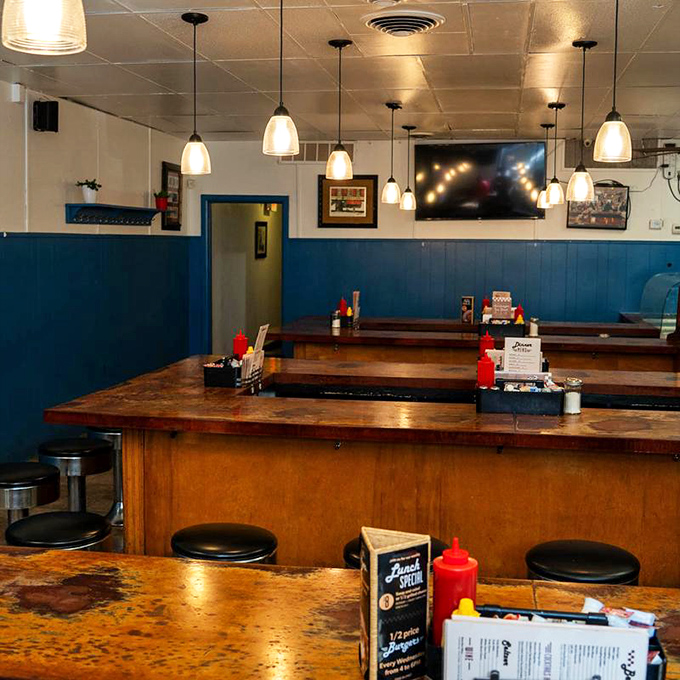 Blue wainscoting, pendant lights, and worn wooden counters create the perfect backdrop for life's most important activity: eating without checking your phone.