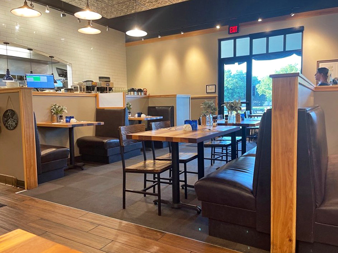 Wooden booths and natural light create dining nooks that feel private yet convivial. Like your favorite aunt's kitchen, if she had professional designers.