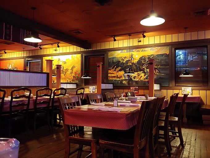 Western-themed murals and red checkered tablecloths create the perfect backdrop for the serious business of steak enjoyment.