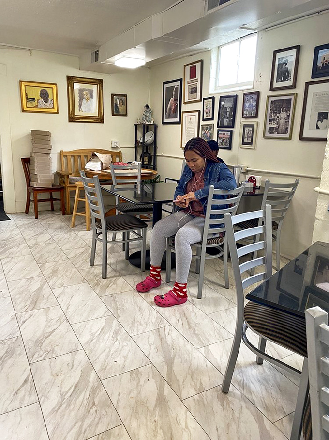 The dining area's marble-like floors and photo-adorned walls tell stories of community long before you've taken your first bite. 