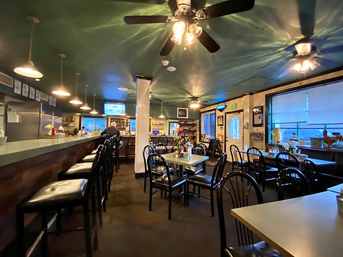 The dining room's ceiling fans and pendant lights cast a warm glow over tables where memories are made between bites of home cooking.