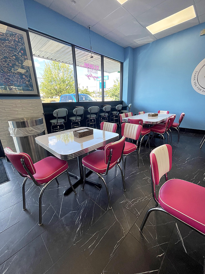 The diner-style seating area feels like a time machine with those cherry-red chairs. Even empty, it practically echoes with the sounds of joy.