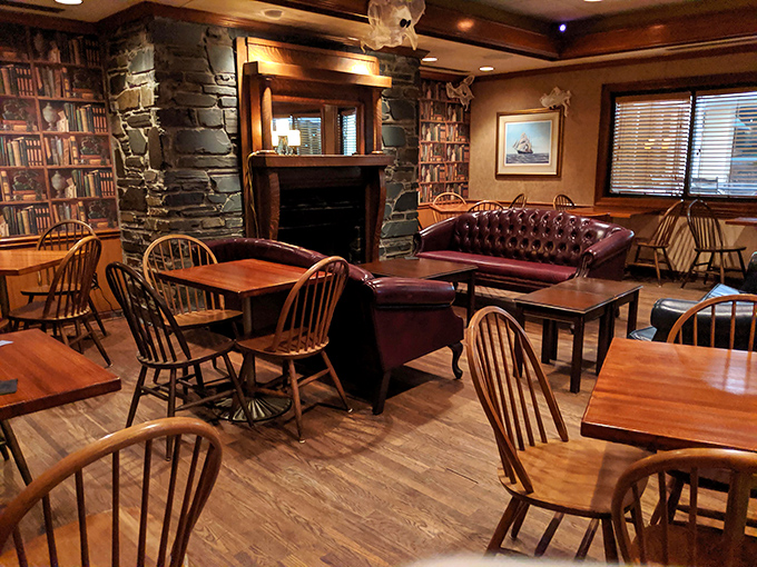 Library wallpaper, wooden chairs, and a stone fireplace create the cozy ambiance of a country club everyone can join. No membership fees, just good food.