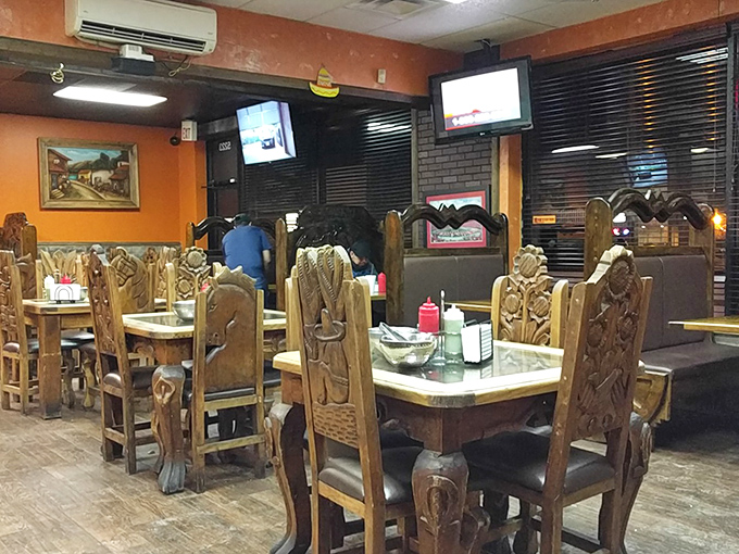 Hand-carved wooden chairs and orange walls create the perfect backdrop for the serious business of taco consumption.