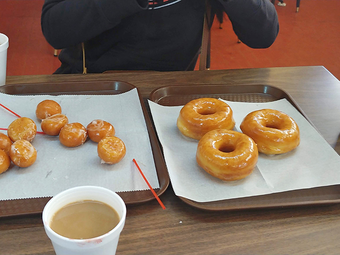 Regular donuts and donut holes share a tray with their larger siblings—the potato flour creating that signature pillowy texture in every size.