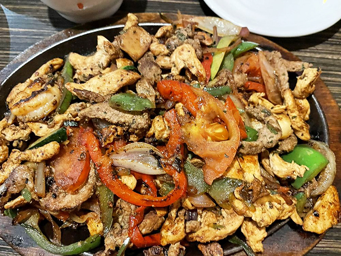 Sizzling fajitas with a rainbow of peppers and perfectly seasoned protein. The steam rising off this skillet is nature's dinner bell.
