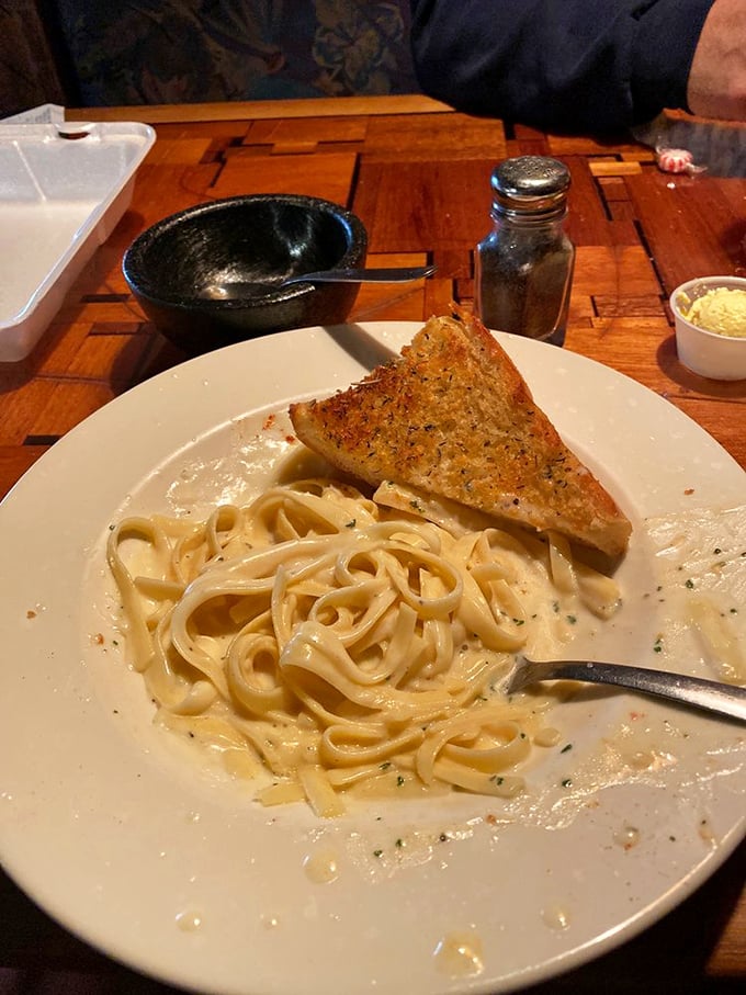 Fettuccine Alfredo so creamy it should come with a warning label. That garlic bread isn't just a side &ndash; it's essential equipment.