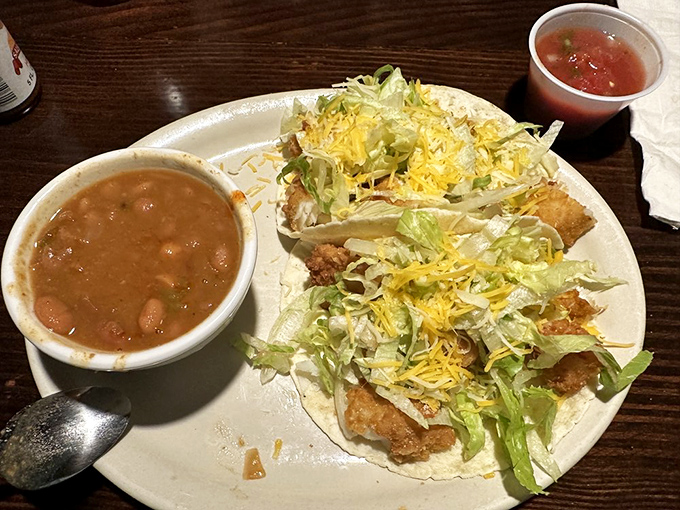 Crispy fish tacos paired with cowboy beans—proof that the best Southwestern cuisine doesn't need fancy plating to impress.