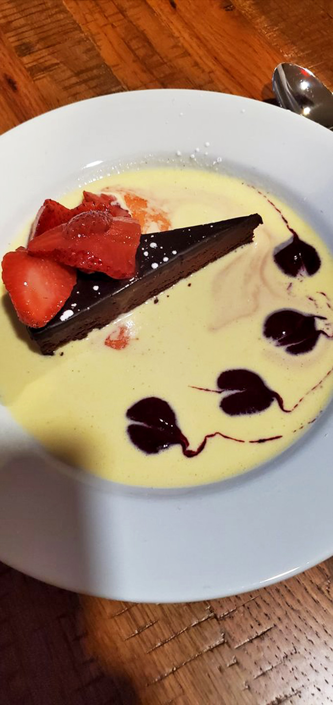 Chocolate torte so rich it probably has its own offshore account. The strawberries are just there to make you feel less guilty.