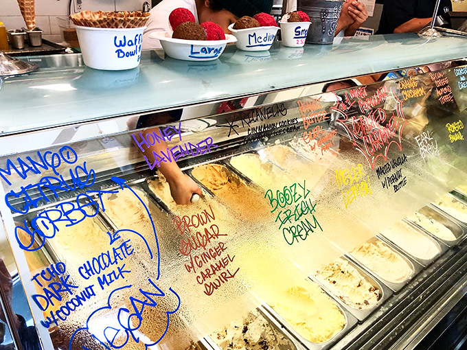 The flavor board reads like poetry. Each handwritten name promises a different journey &ndash; choose your own adventure, but in ice cream form.
