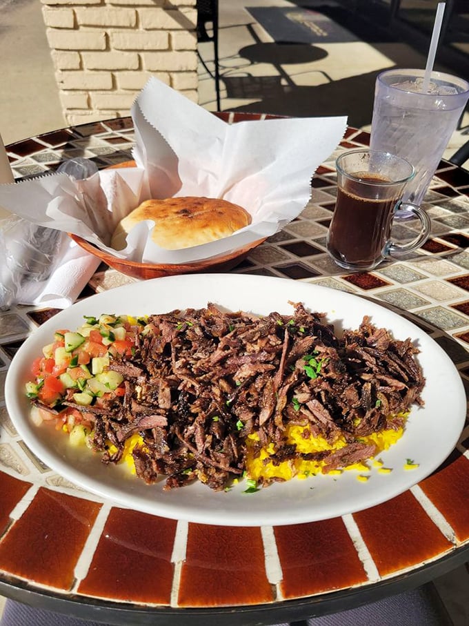Beef shawarma over golden rice with all the fixings. Meat this tender must have been talked to lovingly every day of its life.