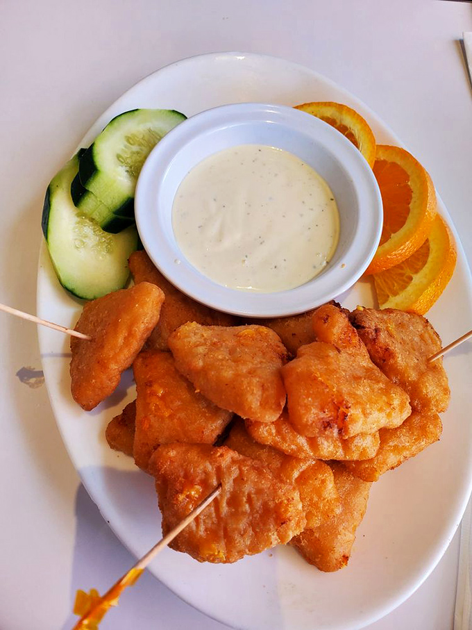 Golden-fried nuggets of happiness served with fresh cucumber and orange slices. The dipping sauce is practically begging for your attention.