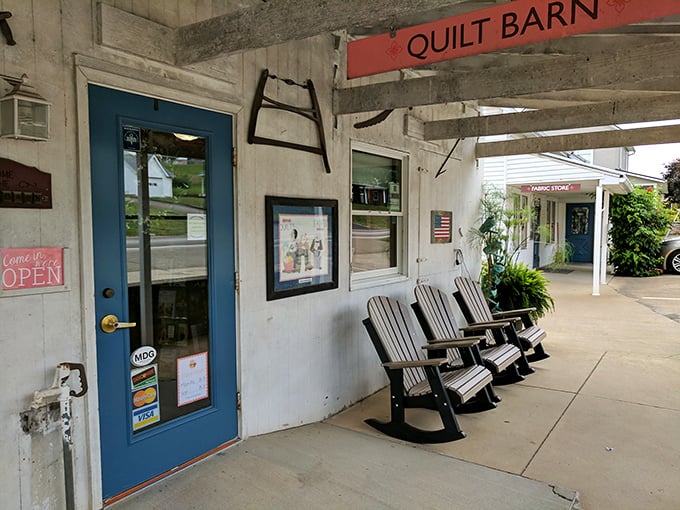 The Quilt Barn's weathered exterior and rocking chairs invite you to slow down. In Charm, even shopping follows the unhurried rhythm of buggy wheels.