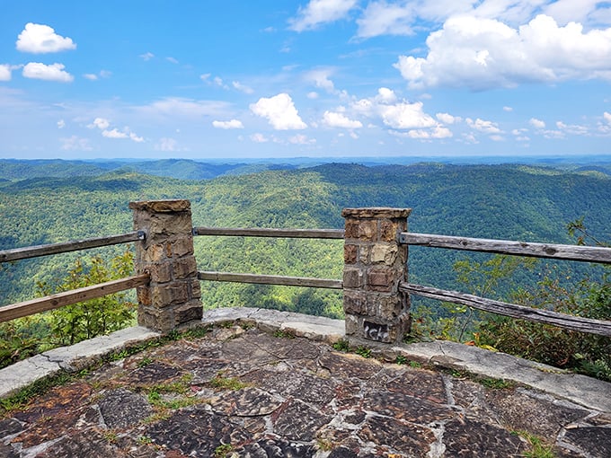 The park's entrance sign stands sentinel against a backdrop of rolling hills. First impressions matter, and Kingdom Come nails it with rustic charm.