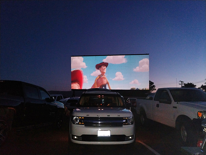 Woody from Toy Story welcomes families to his world, proving some characters are simply larger than life when projected under the stars.