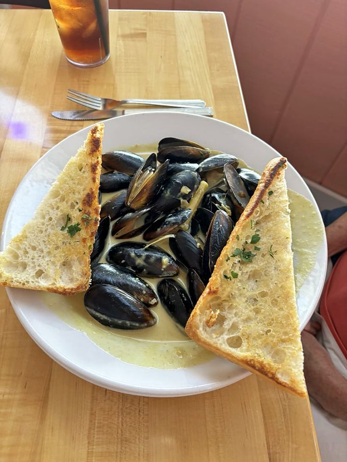These mussels have clearly been living their best life before arriving at your table in a bath of garlicky, wine-infused heaven.