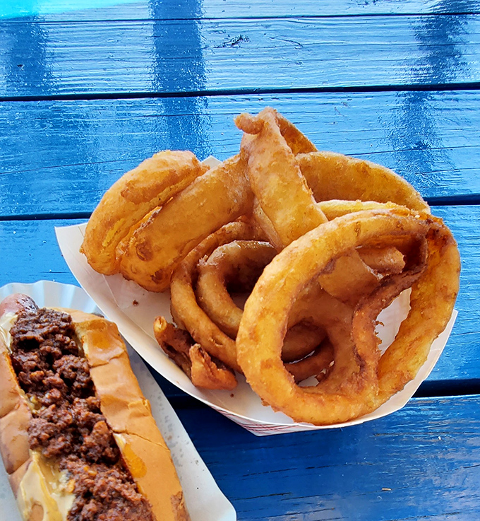 Golden rings of happiness stacked alongside a chili dog. The kind of meal that makes you forget you ever knew the word "kale."