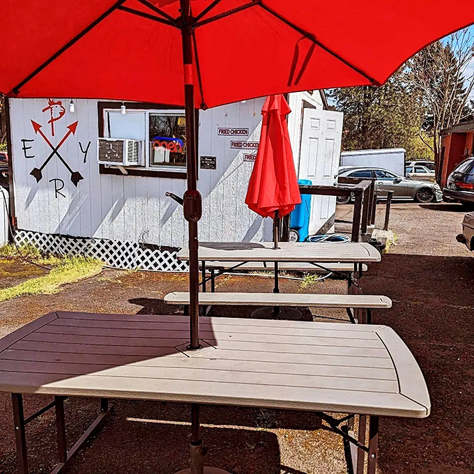 The blue-painted side wall and string lights transform this humble shack into a beacon for fried chicken pilgrims seeking spicy salvation. 
