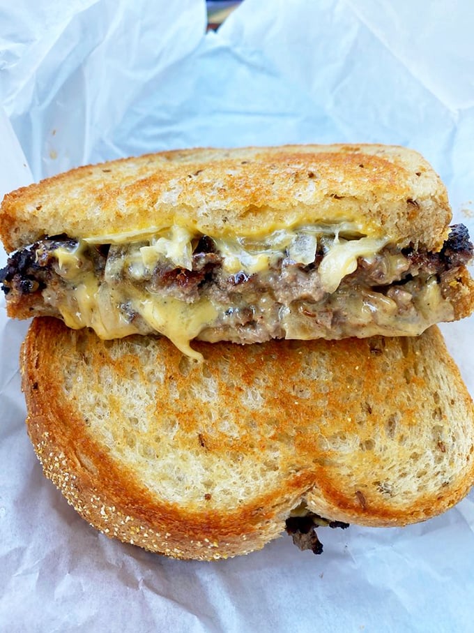 The patty melt: where burger meets grilled cheese in a beautiful marriage that would make even the most jaded foodie weep with joy.