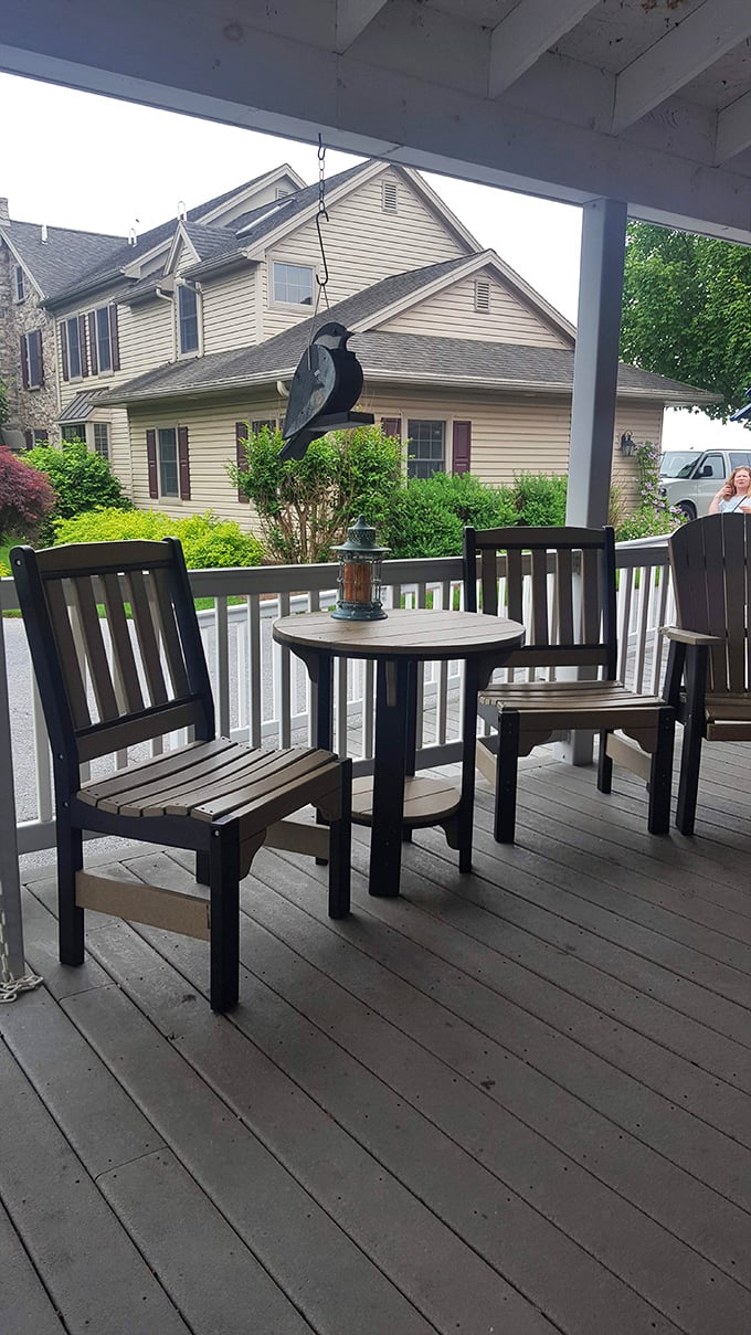 The porch seating area offers a perfect perch for pretzel consumption, complete with a bird-shaped wind chime that seems to say, "Eat more pie."
