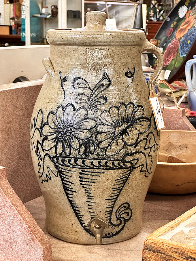 This hand-decorated stoneware water cooler tells stories of summer gatherings before air conditioning was even a dream. Folk art that actually did something.