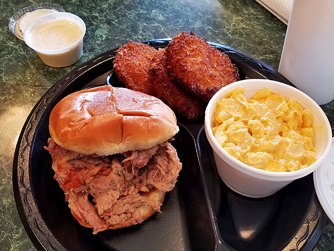 This pulled pork sandwich with hush puppies and mac & cheese is the holy trinity of Southern comfort on a single plate.