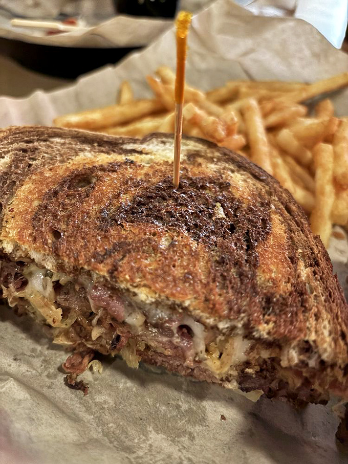 The Reuben sandwich: where sauerkraut, corned beef, and Swiss cheese have their most delicious group therapy session. That toast job deserves an award.