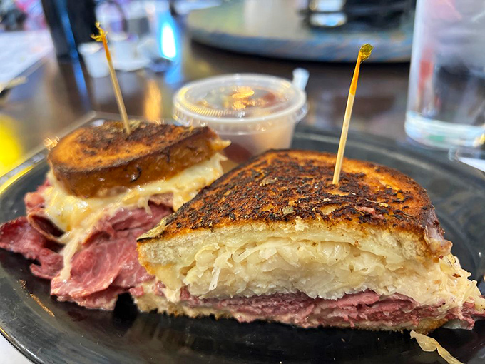 The perfect Reuben reveals itself in layers: toasty bread giving way to melted cheese, then tangy sauerkraut, and finally, that glorious hand-sliced meat.