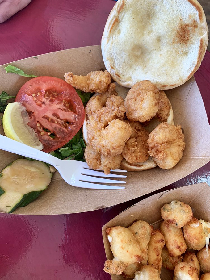 Behold the shrimp sandwich in its cardboard throne, where each perfectly seasoned bite makes you question why you ever eat anything else.