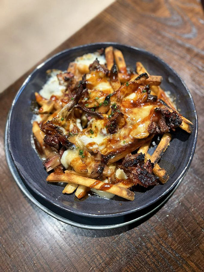 These loaded fries aren't simply a side dish; they're an achievement in culinary architecture&mdash;brisket, cheese, and sauce creating a monument to excess.