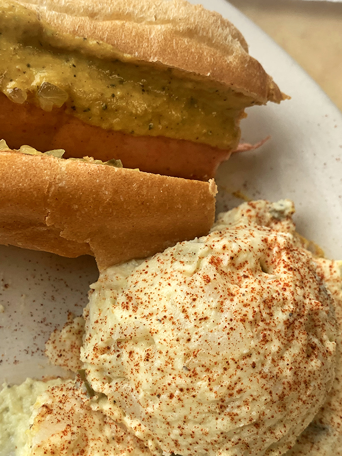 This isn't just a sandwich; it's architectural genius&mdash;thick-cut meat on fresh bread with a side of potato salad that deserves its own fan club. 