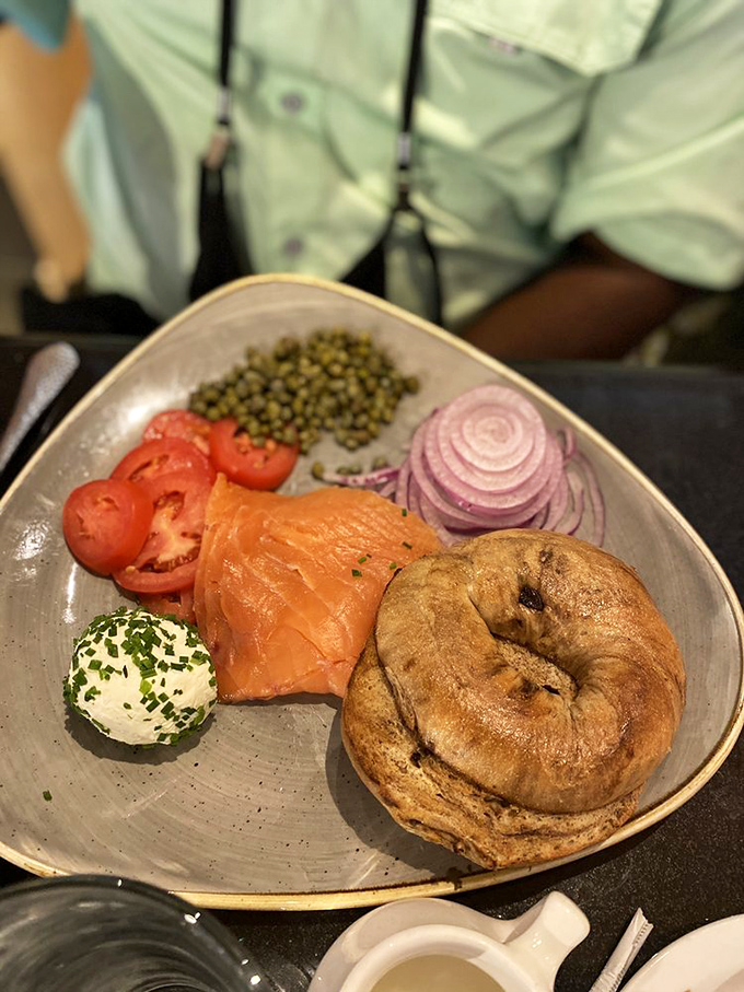 The smoked salmon plate arrives like a color wheel of breakfast joy—silky fish, vibrant tomatoes, and a bagel that's begging for your attention.