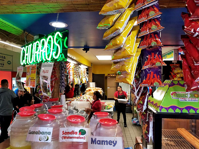 The neon churro sign beckons like a lighthouse for the sweet-toothed. Fresh fruit aguas frescas in rainbow jars promise refreshment after hours of exploration.