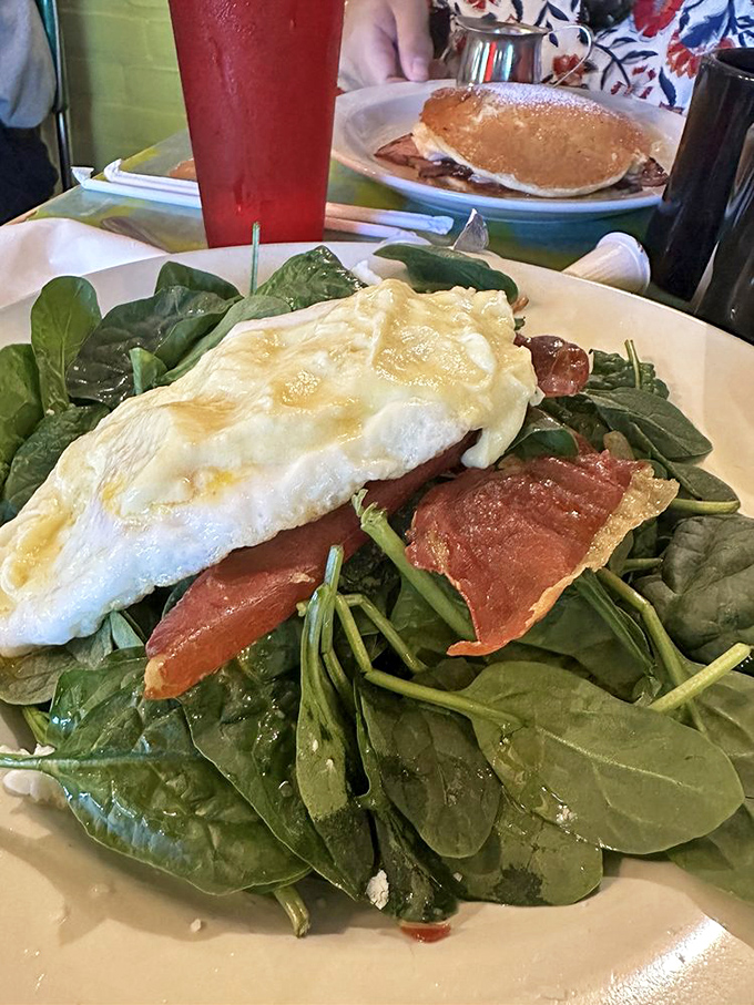 A breakfast that refuses to be boring. Vibrant spinach, eggs, and potatoes share the plate like colorful characters in a delicious morning story.