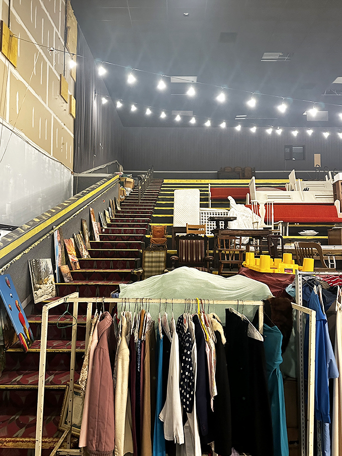 String lights illuminate this cavernous section where furniture and clothing await their second chance at making a house feel like home.