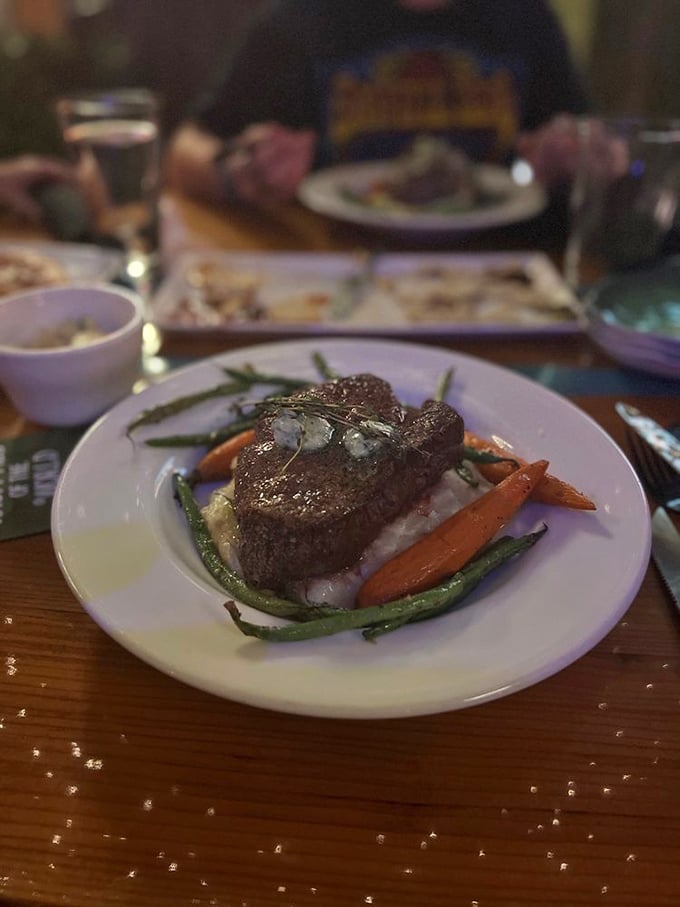 This steak isn't just cooked&mdash;it's been treated with the reverence a fine cut deserves, resting atop vegetables like a king on his throne.