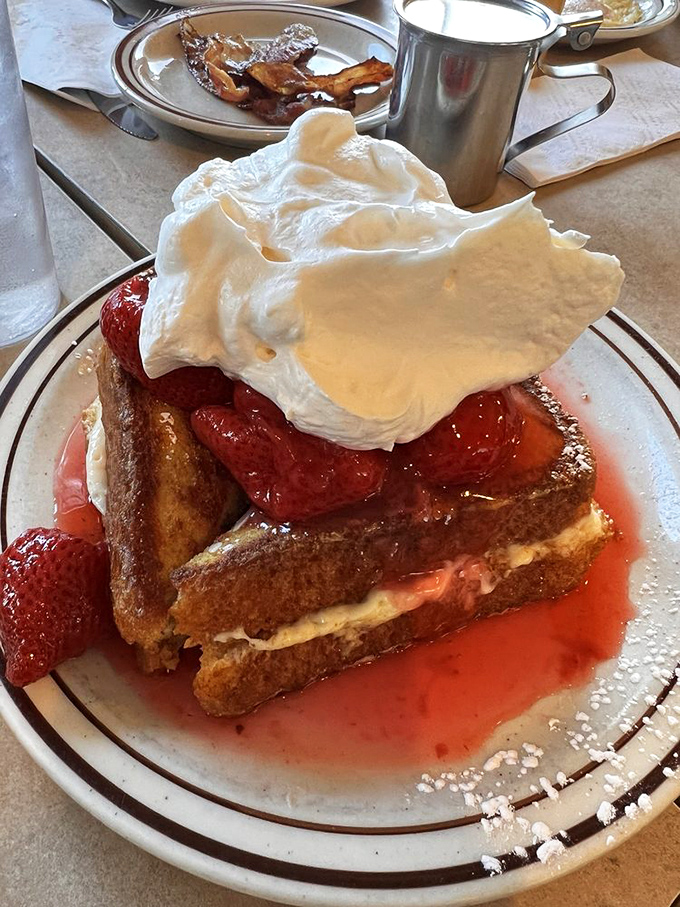 French toast that looks like it's auditioning for a dessert menu&mdash;strawberries, cream, and bread that sacrificed itself for a greater purpose.
