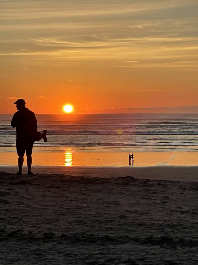Nature's nightly masterpiece. The Oregon coast sunset transforms ordinary beachgoers into silhouetted philosophers contemplating life's bigger questions.
