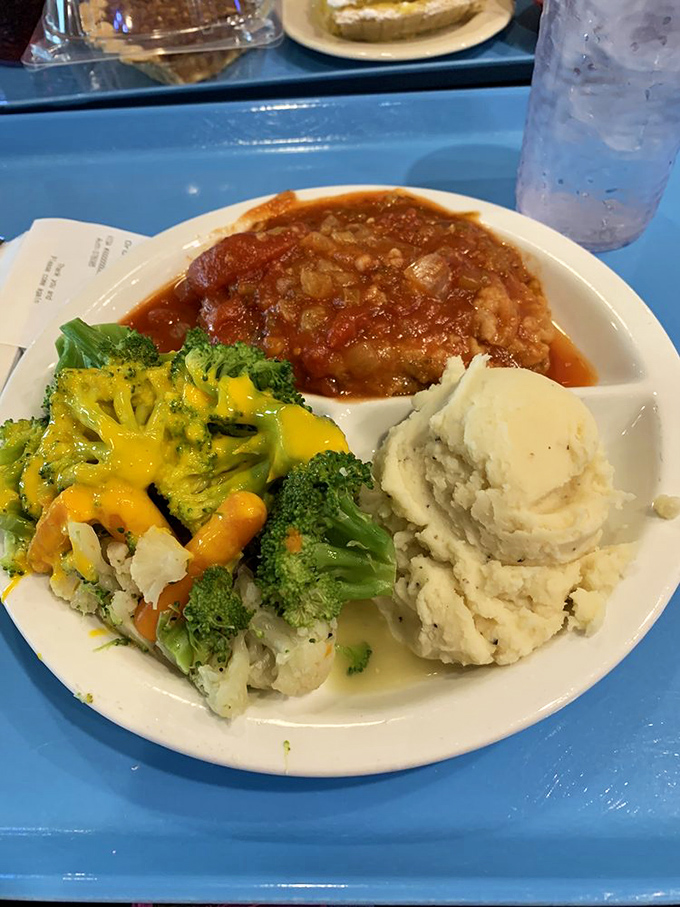 The kind of hearty plate that makes you understand why Midwesterners survive brutal winters&mdash;broccoli with cheese and mashed potatoes flanking what appears to be Swiss steak.