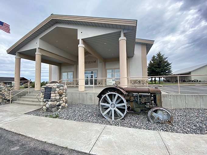 The museum welcomes visitors with the universal language of antique farm equipment. That tractor has seen things your smartphone couldn't begin to comprehend.