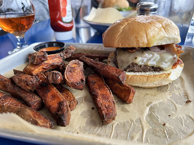 The Astro burger: where beef meets destiny. This towering creation makes you wonder if your jaw will unhinge like a snake's. 