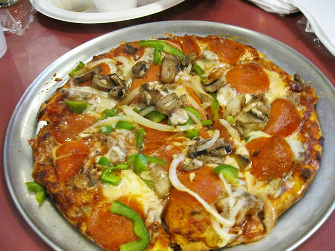 The Deluxe pizza doesn't just bring toppings to the table&mdash;it orchestrates a perfect harmony of pepperoni, mushrooms, and green peppers on a golden crust.